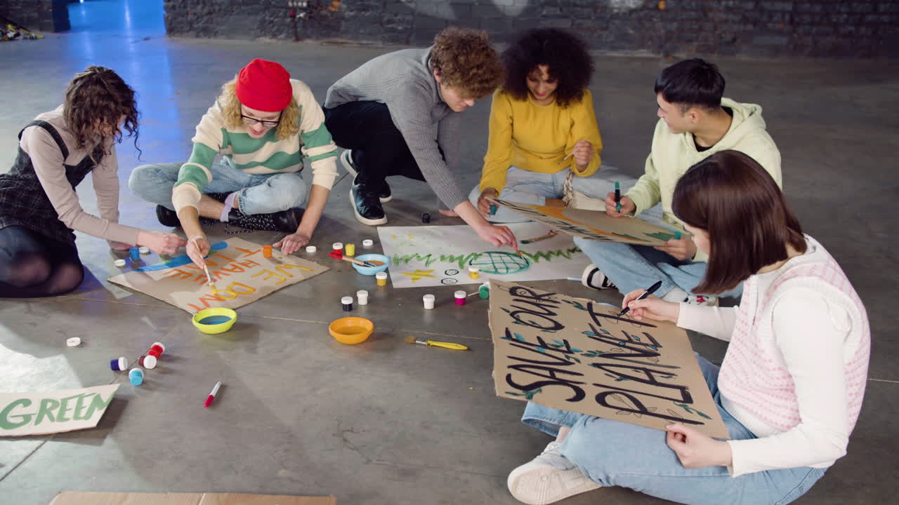 Free stock video - Young environmental activists painting placards ...