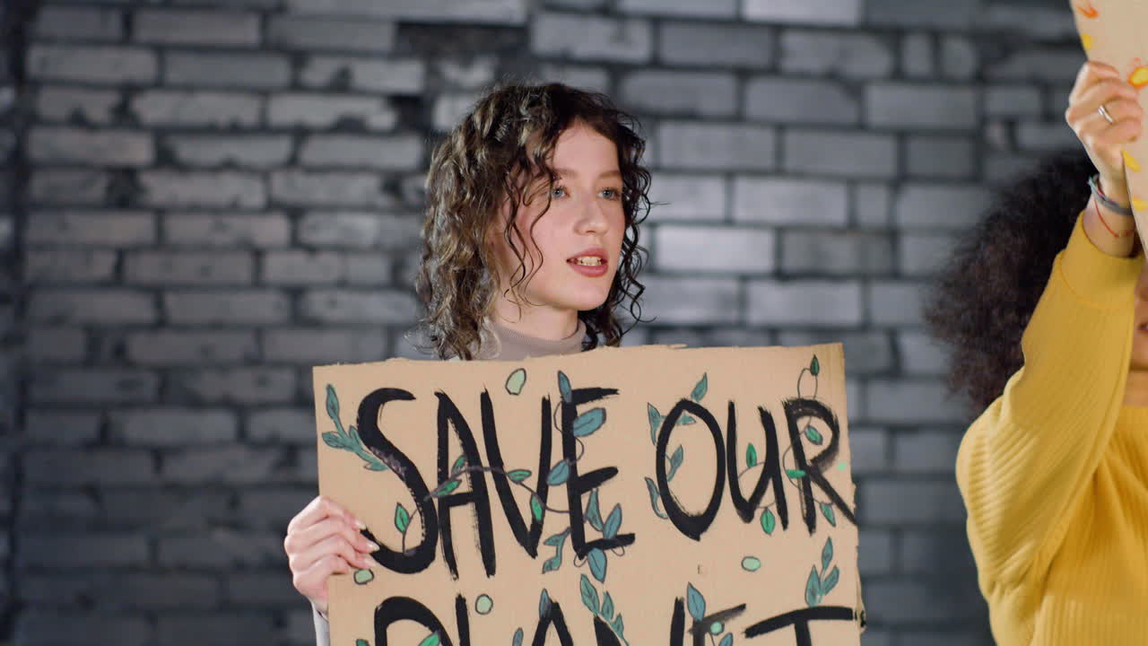 Free stock video - Young environmental activist holding a cardboard ...