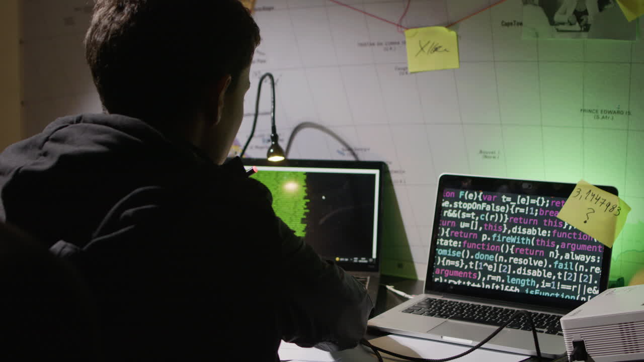 Free stock video - Back view of a hacker at late night working on ...