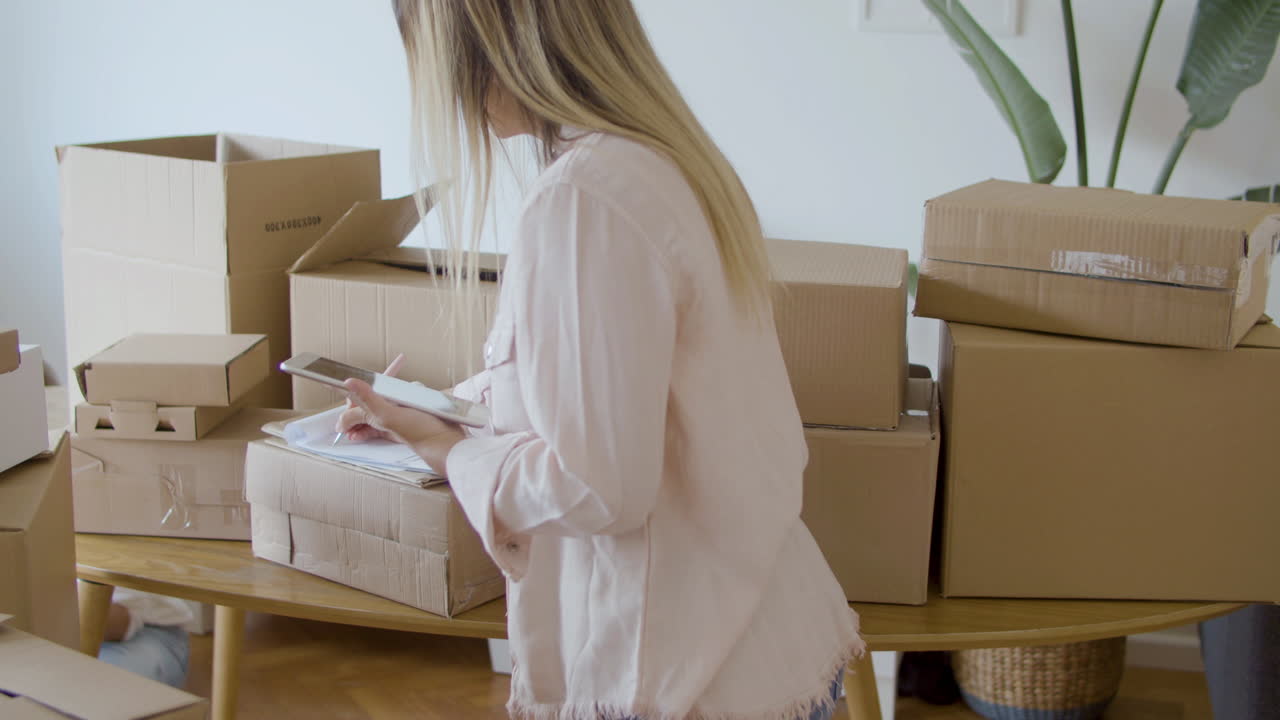Free stock video - Young female entrepreneur checking stock inventory