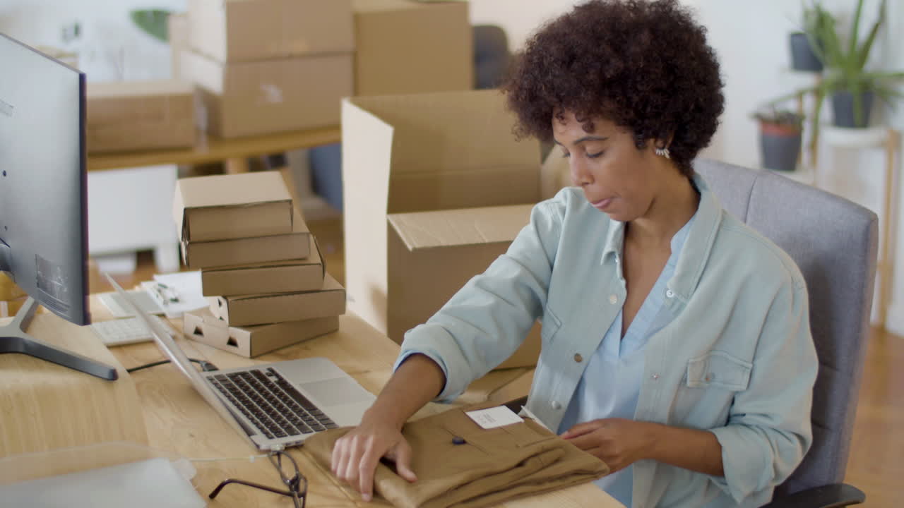 Free stock video - Focused black woman checking clothing paper tag and ...