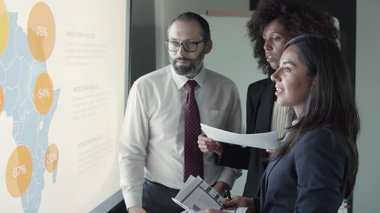 Free stock video - Successful focused partners discussing analytics data