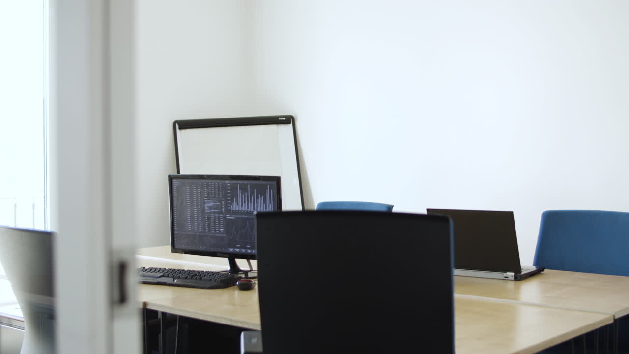 Free stock video - Empty office space with computer, desk and chairs