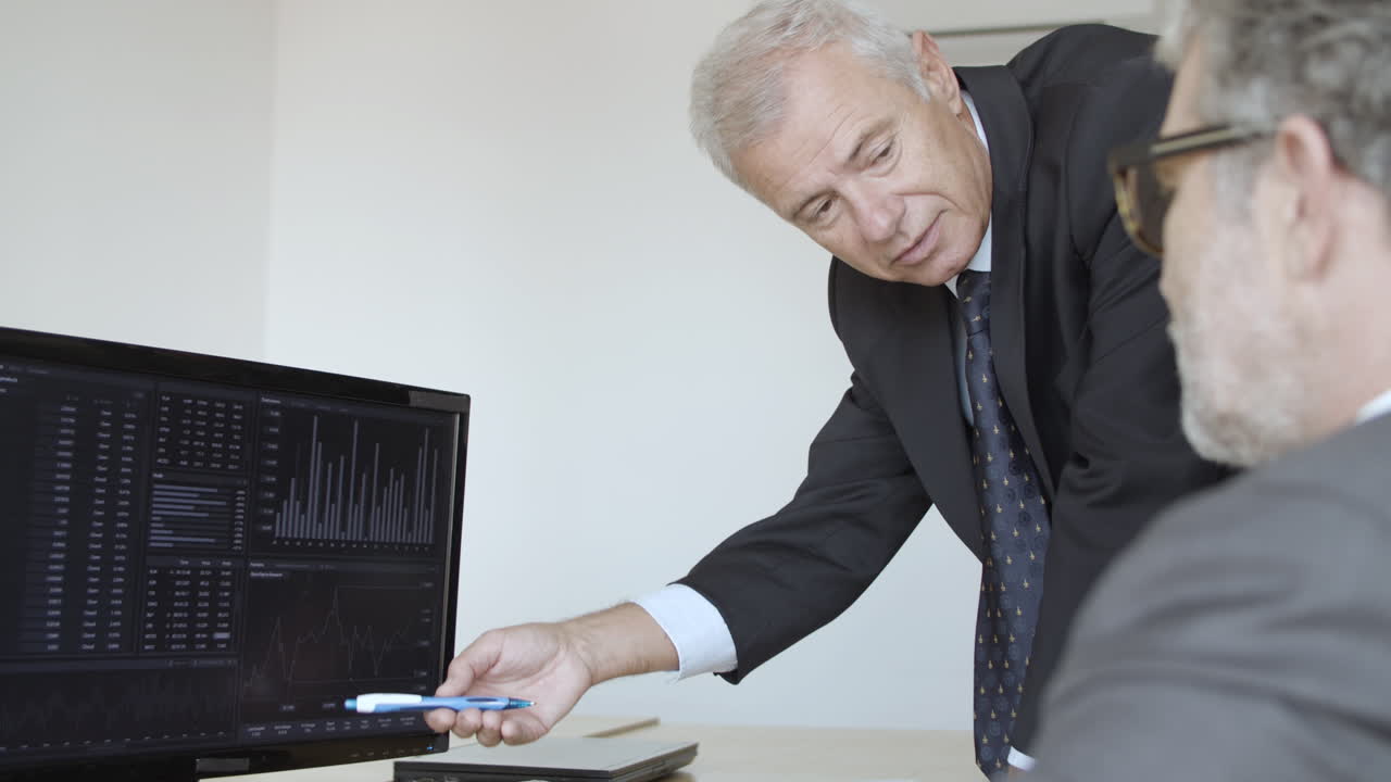 Free stock video - Serious grey haired investors discussing stock ...