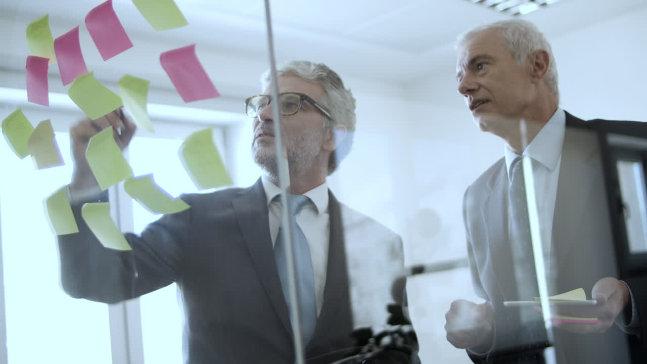 Free stock video - Serious mature company executives working on project ...