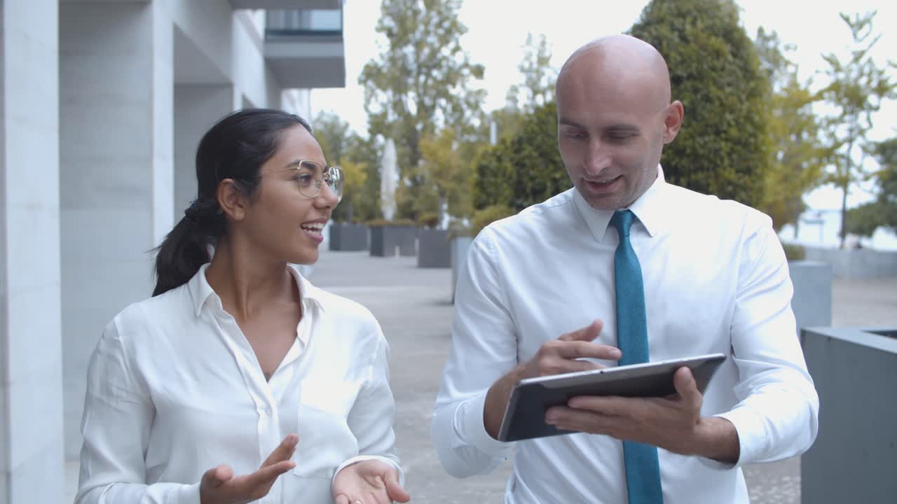 Free stock video - Front view of two business colleagues discussing ...