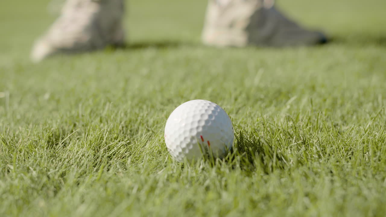 Free stock video - Golf ball on grass field near practicing player