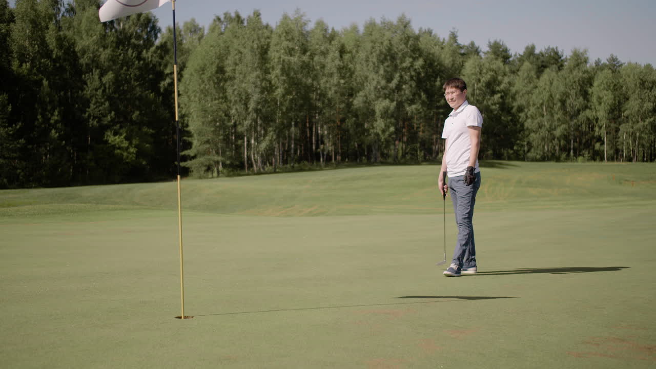 Free stock video - Male golf player missing the hit on the grass field