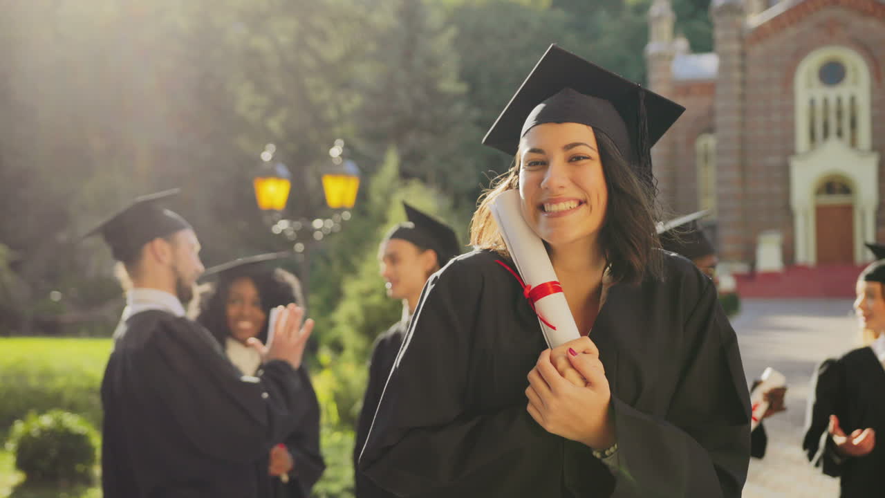 Free stock video - Portrait of the happy young female graduate in a ...