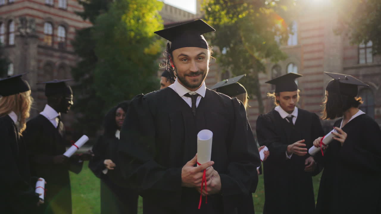 Free stock video - Portrait of a young man graduate standing in ...