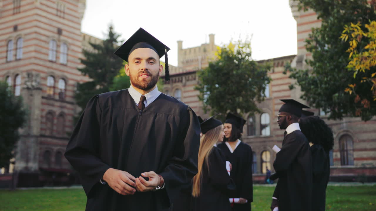 Free stock video - Portrait shot of the young graduated man in black ...
