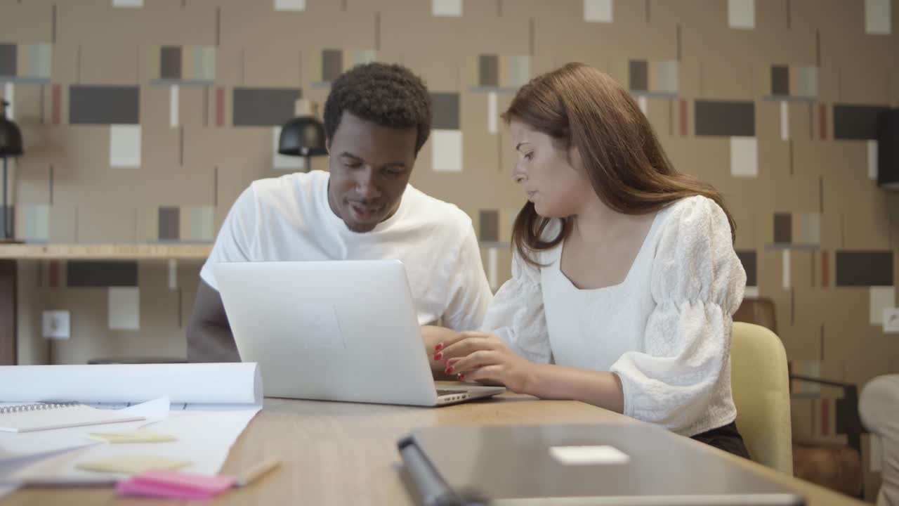 Free stock video - Serious young colleagues working together