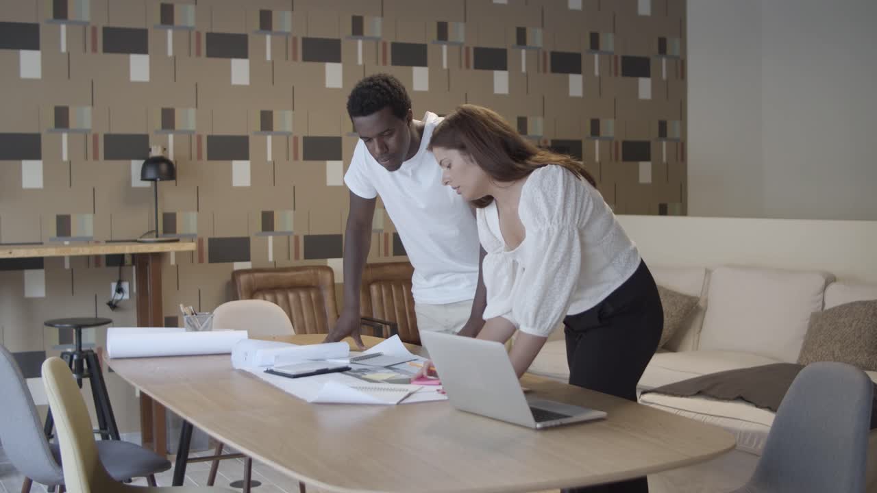 Free stock video - Couple of startup partners standing at table