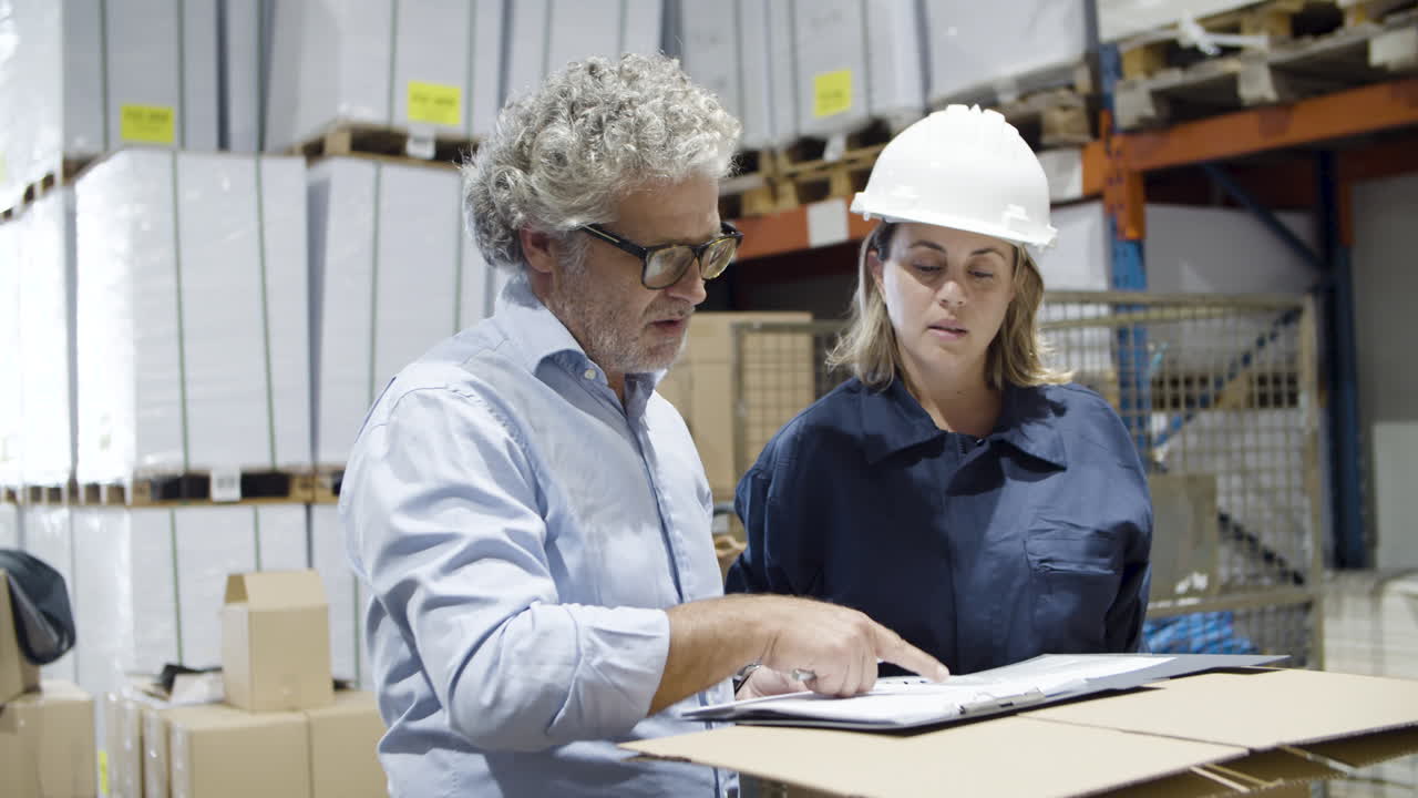 Free stock video - Serious safety inspector checking warehouse with ...