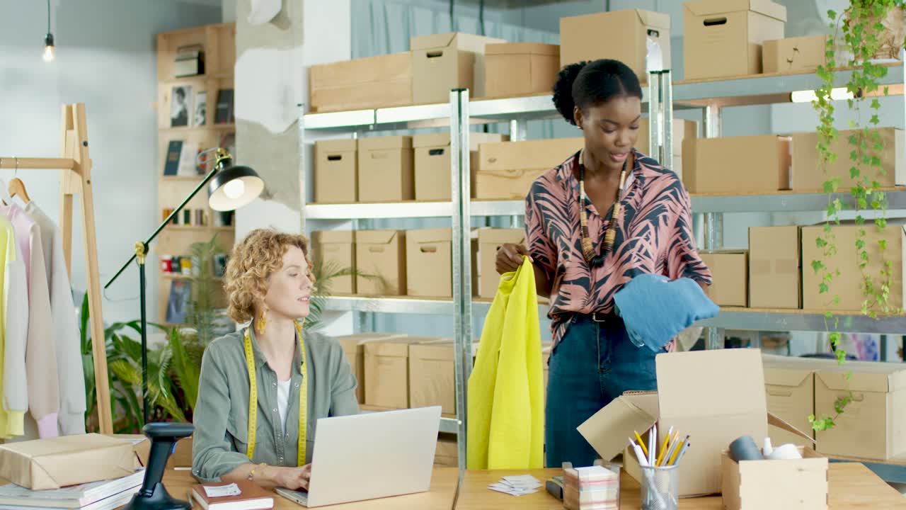 Free stock video - African american woman designer packing ordered ...