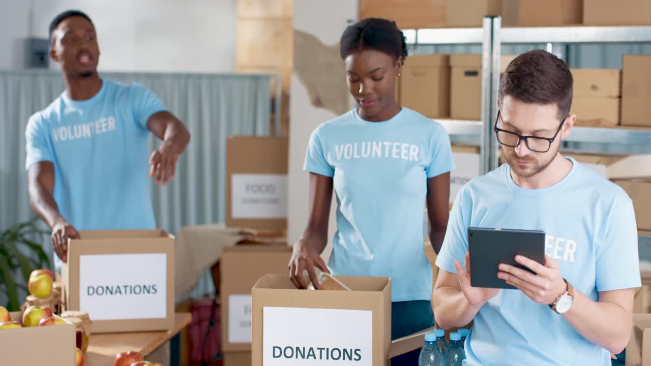 Free stock video - Multiethnic group of volunteers packing boxes with ...