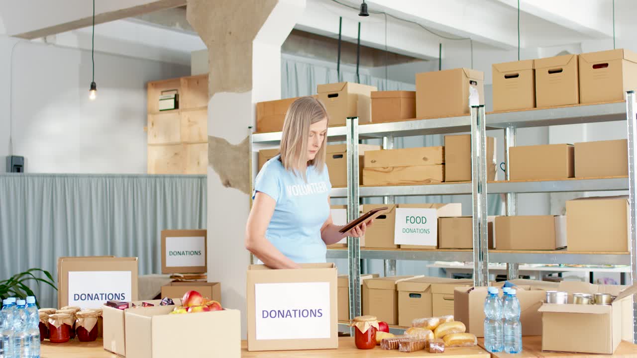 Free stock video - Caucasian woman volunteer packing donation boxes ...