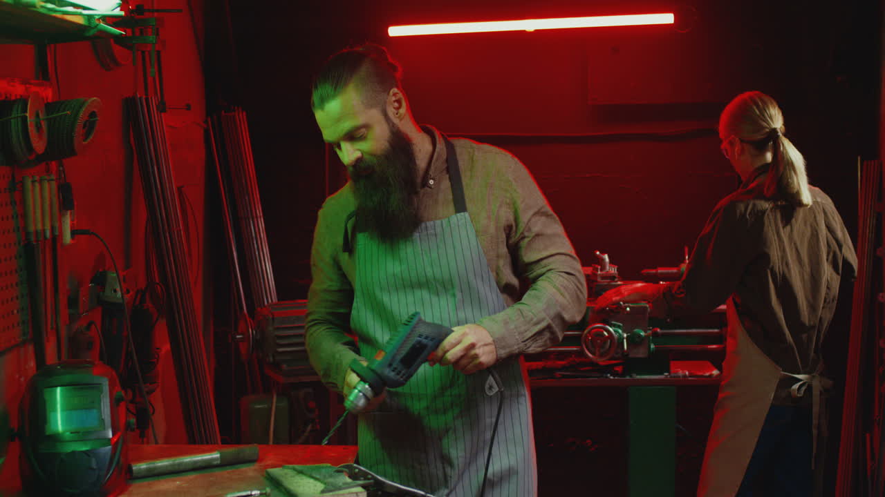 Free stock video - Caucasian young man welder with long beard and apron ...