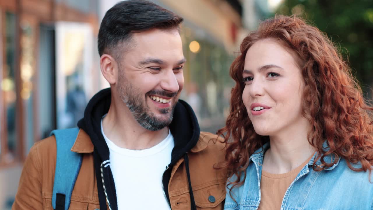 Free stock video - Close-up view of caucasian man and redheaded woman talking and walking down ...