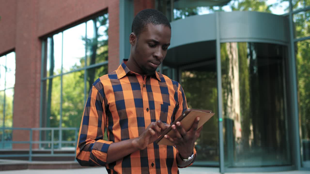 Free stock video - Camera zooming on african american man using a ...