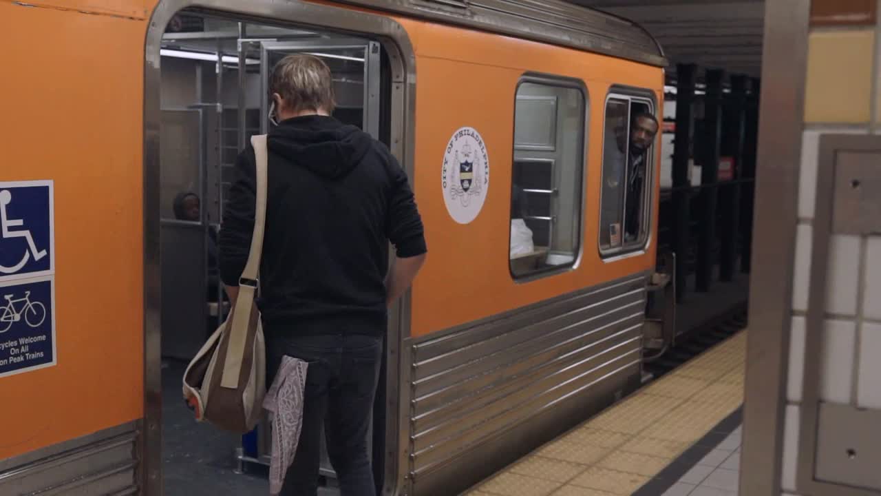 Premium stock video - Slow motion clip of man getting on train