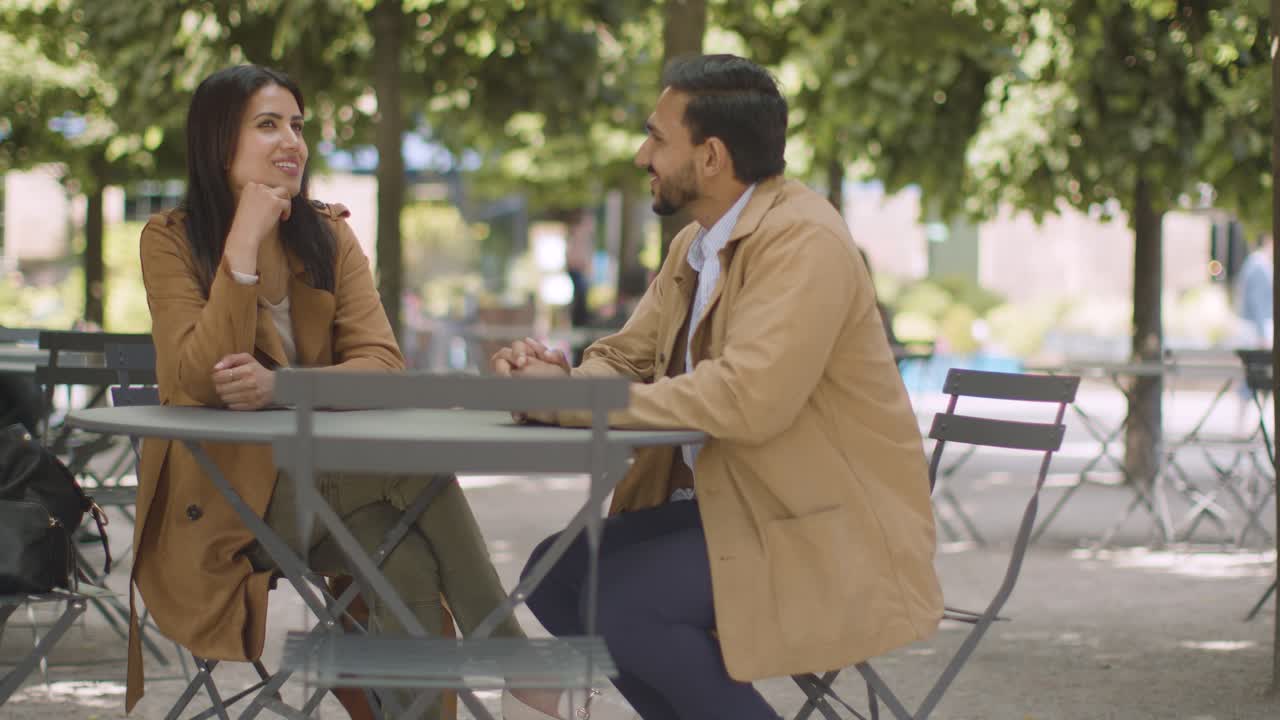 Free stock video - Muslim couple on date sitting at outdoor table on ...