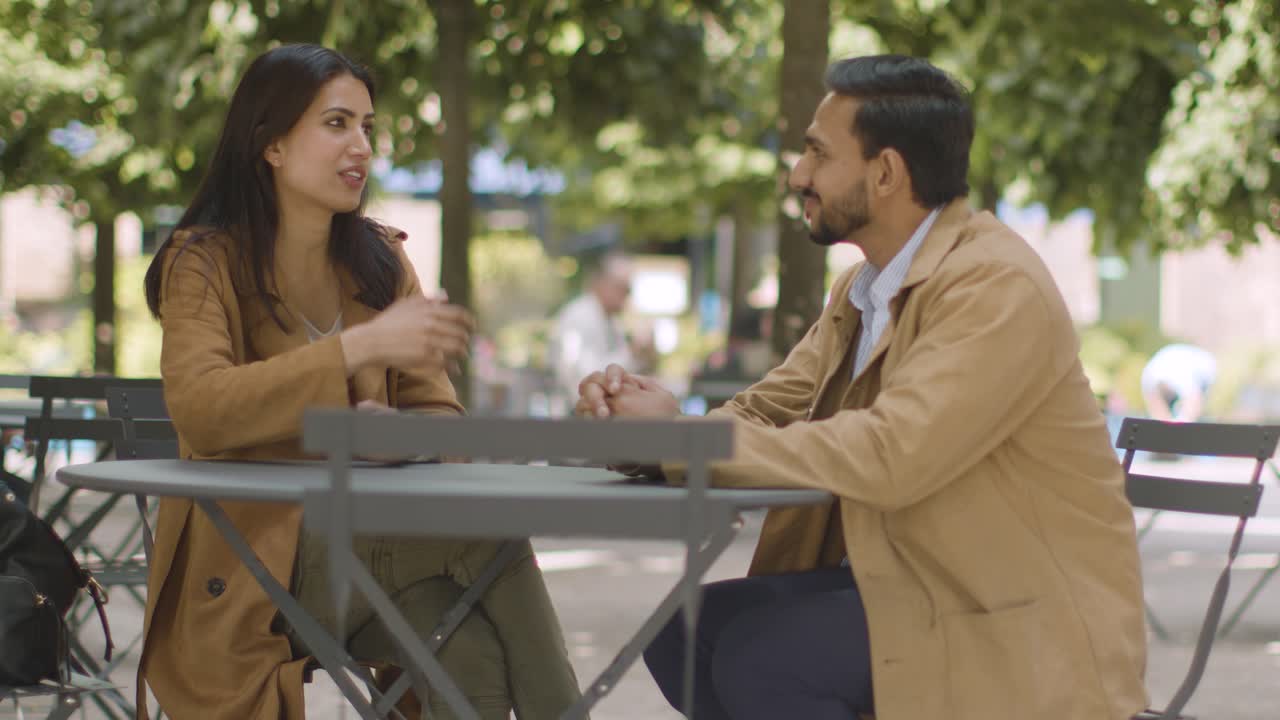 Free stock video - Muslim couple on date sitting at outdoor table on ...