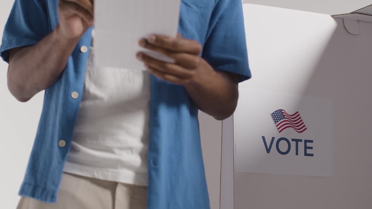 Free stock video - Close up of man next to booth with ballot paper in ...