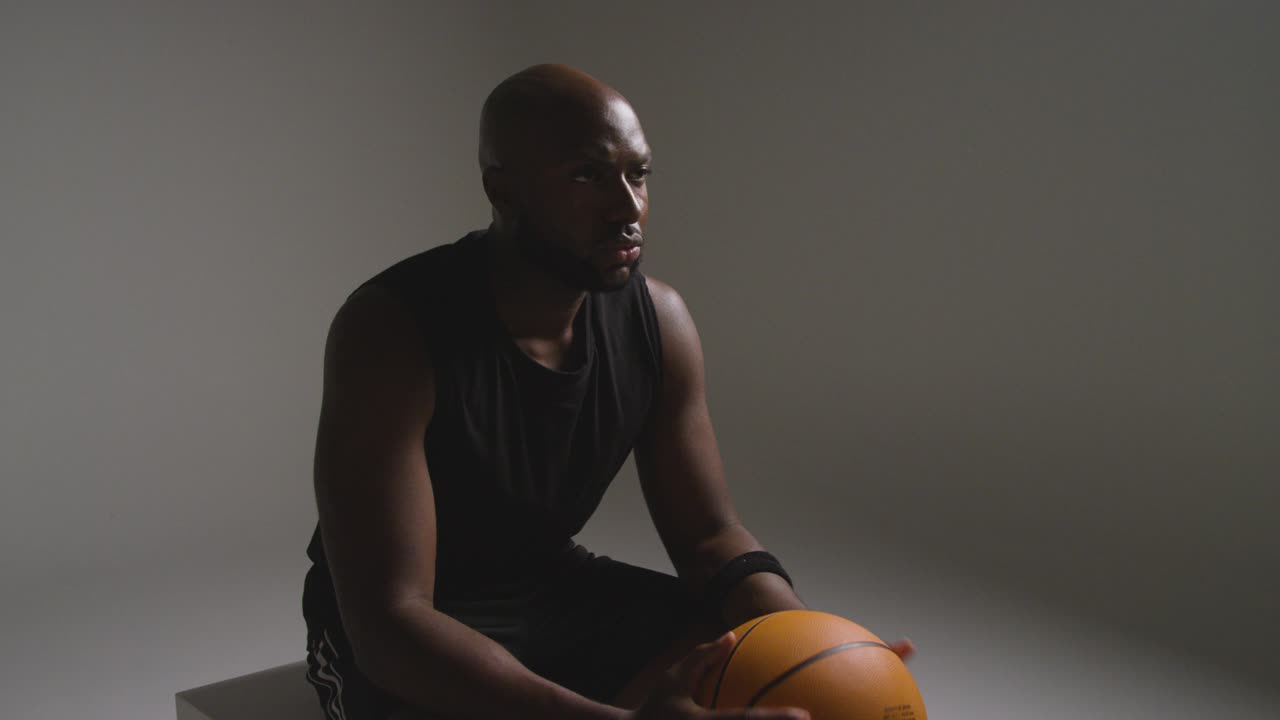 Free stock video - Studio shot of seated male basketball player with ...