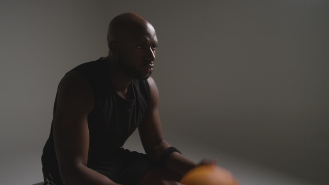 Free stock video - Studio shot of seated male basketball player with ...