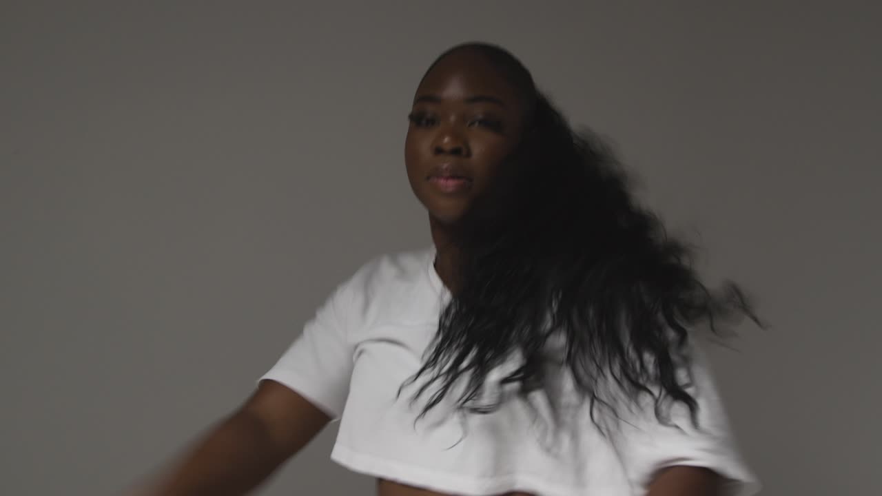 Free stock video - Studio portrait shot of young woman dancing with low ...