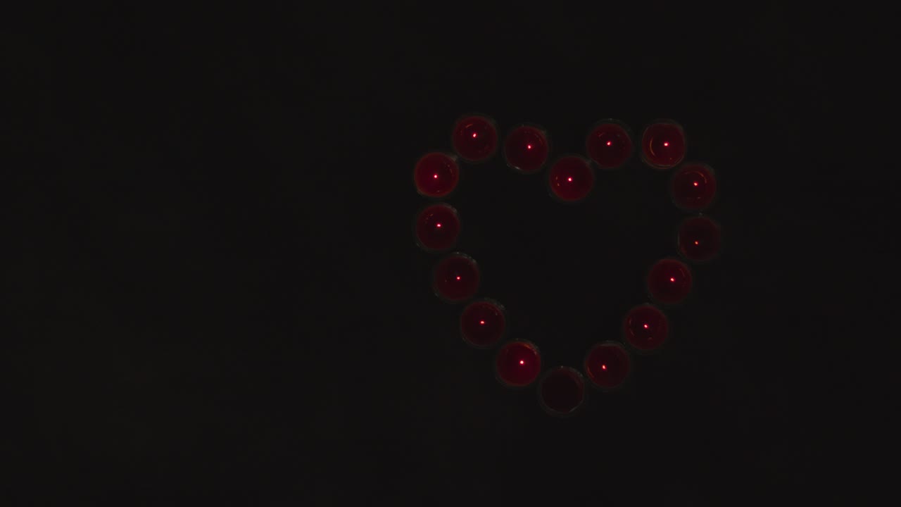 Free stock video - Overhead shot of lit red candles in shape of ...