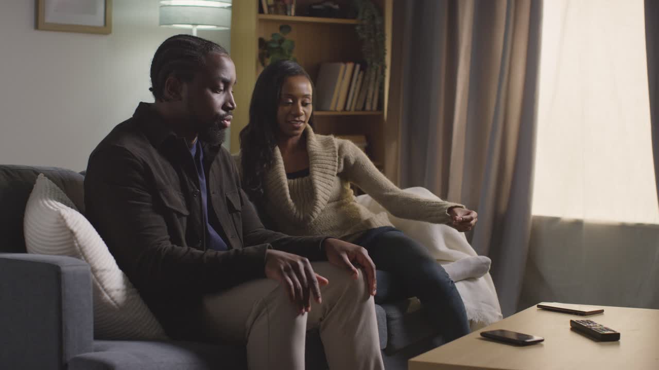 Free stock video - Couple at home sitting on sofa in lounge having ...