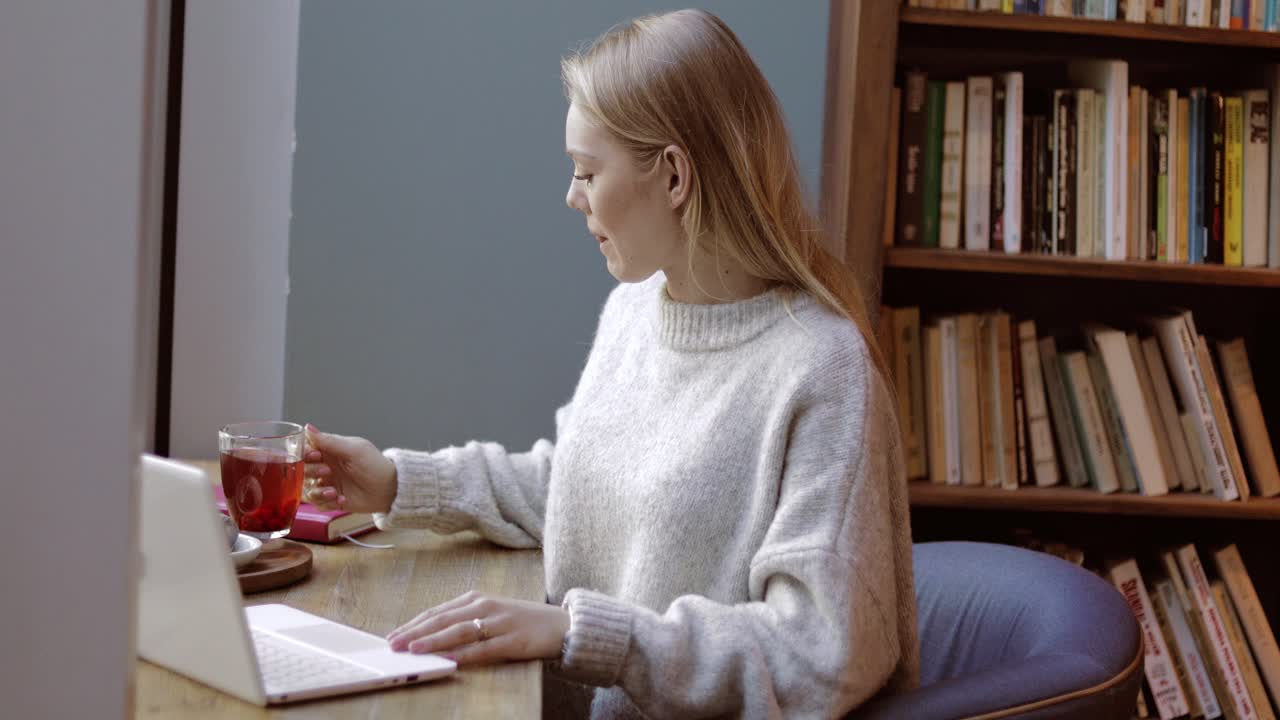 Premium stock video - Beautiful woman using laptop