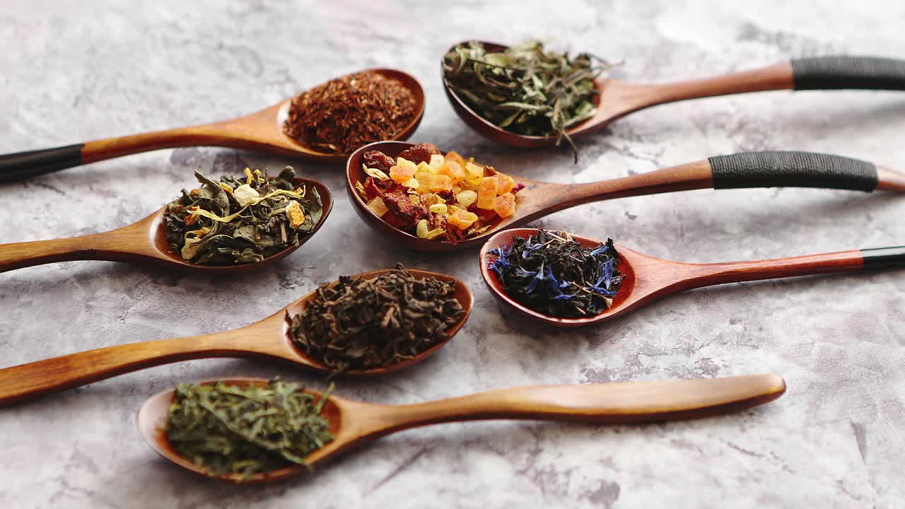 Premium stock video - Spoons with different types of dry tea leaves
