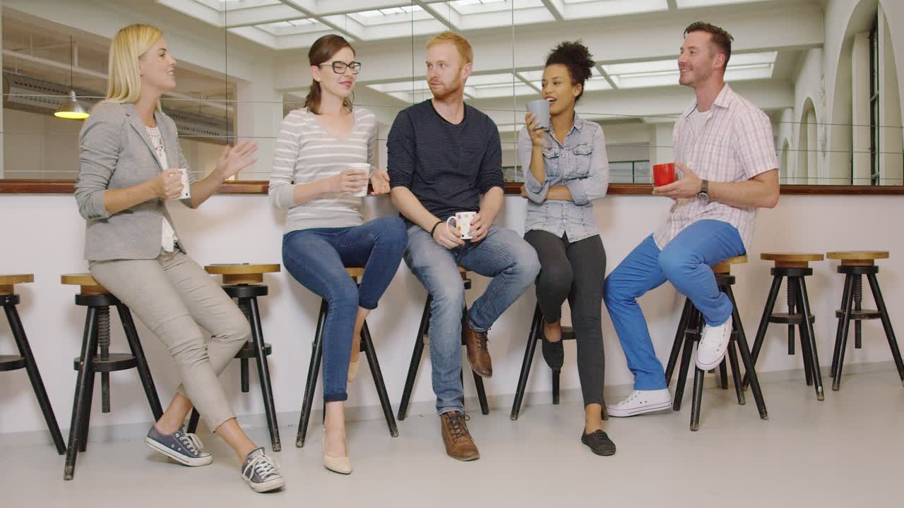 Premium stock video - People with coffee listening to their colleague