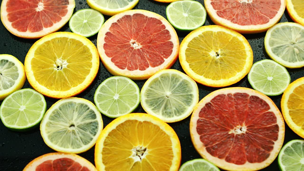 Premium stock video - Assortment of sliced citruses