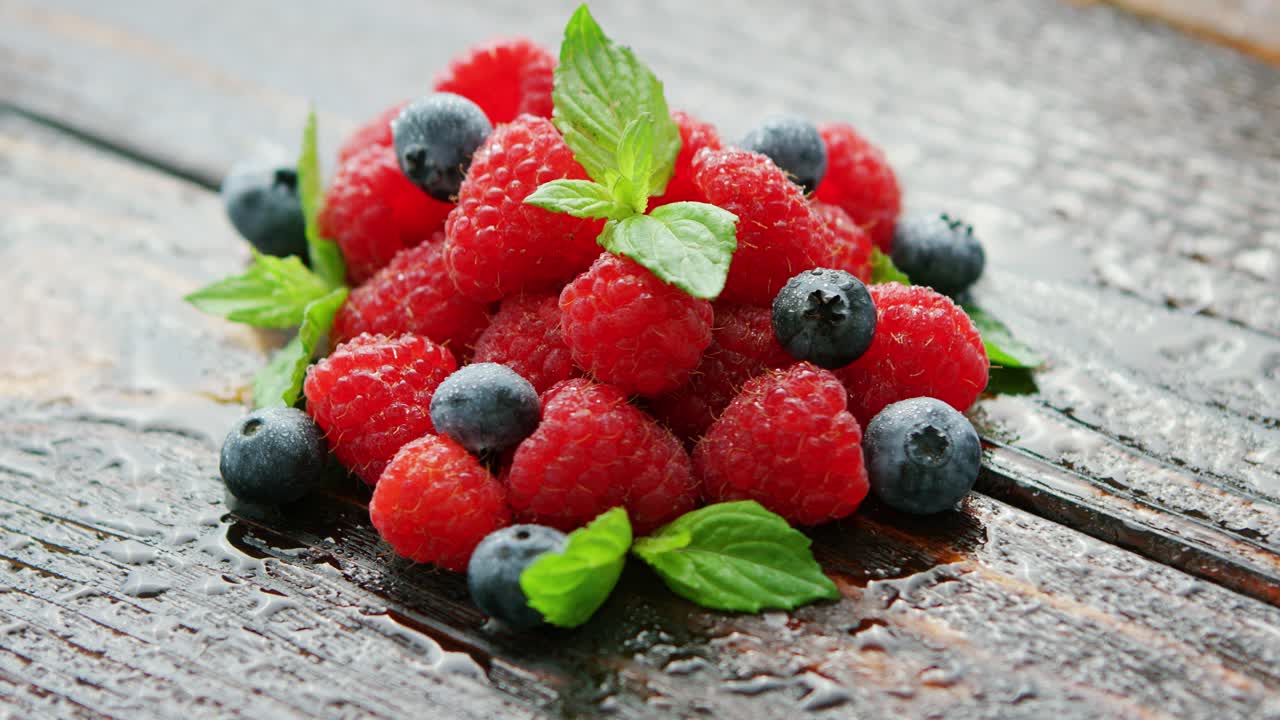 Premium stock video - Raspberry and blueberry on table