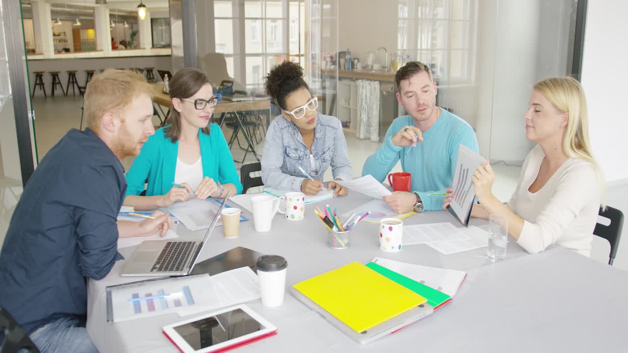 Premium stock video - People watching graphics and statistics