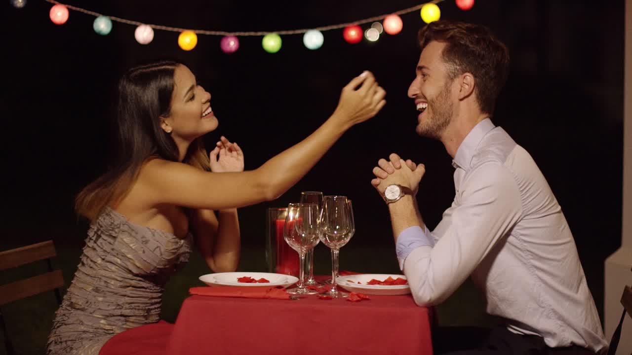 Premium stock video - Couple holds hands across table and smiles