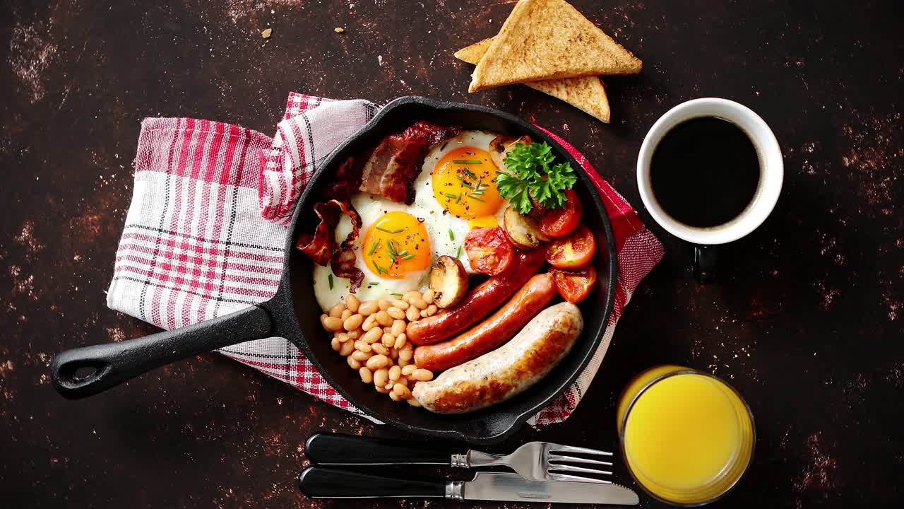 Premium stock video - Delicious english breakfast in iron cooking pan