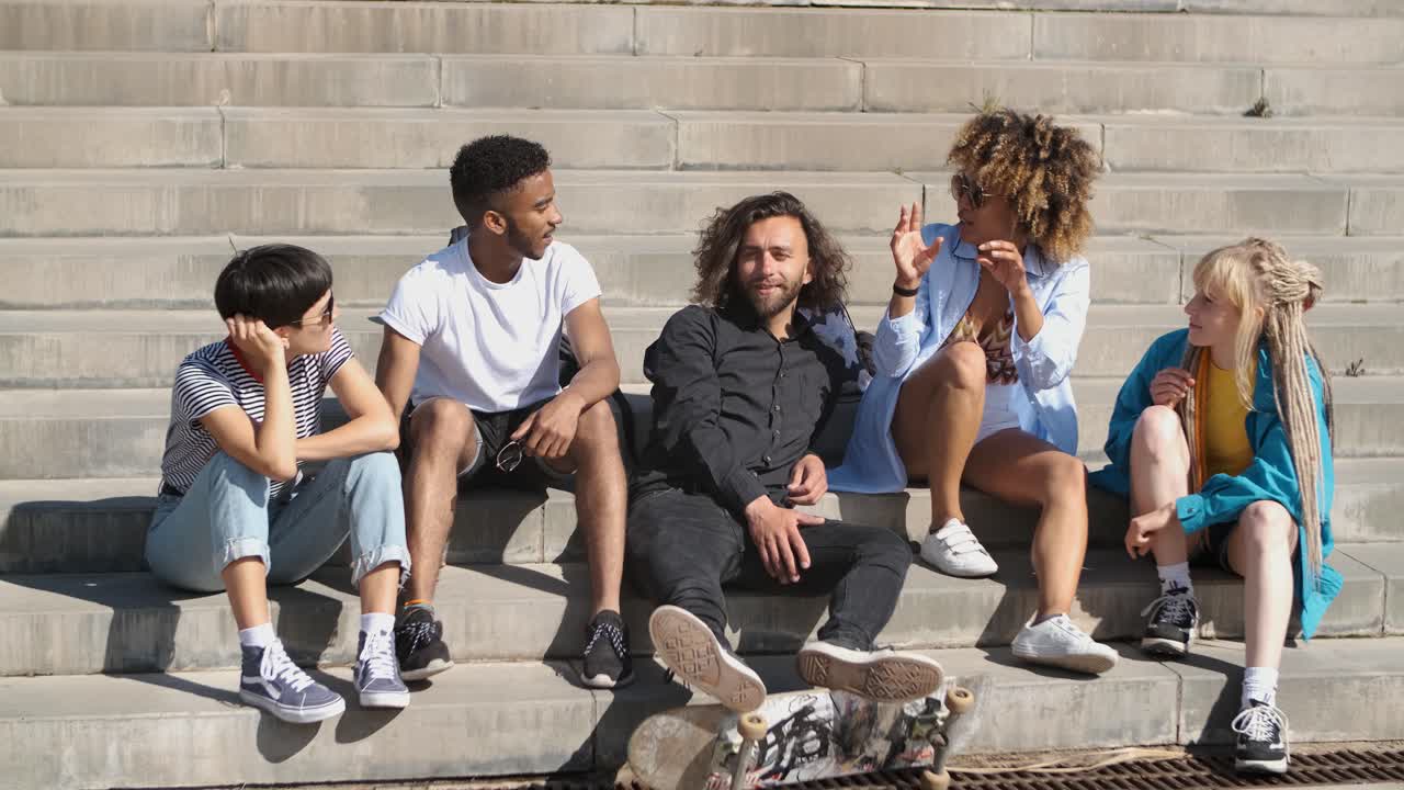 Premium stock video - Young stylish friends on street steps