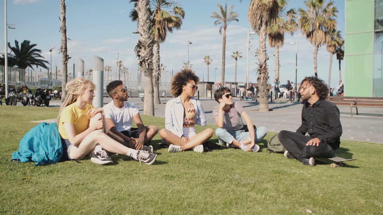 Premium stock video - Chatting modern people on street meadow