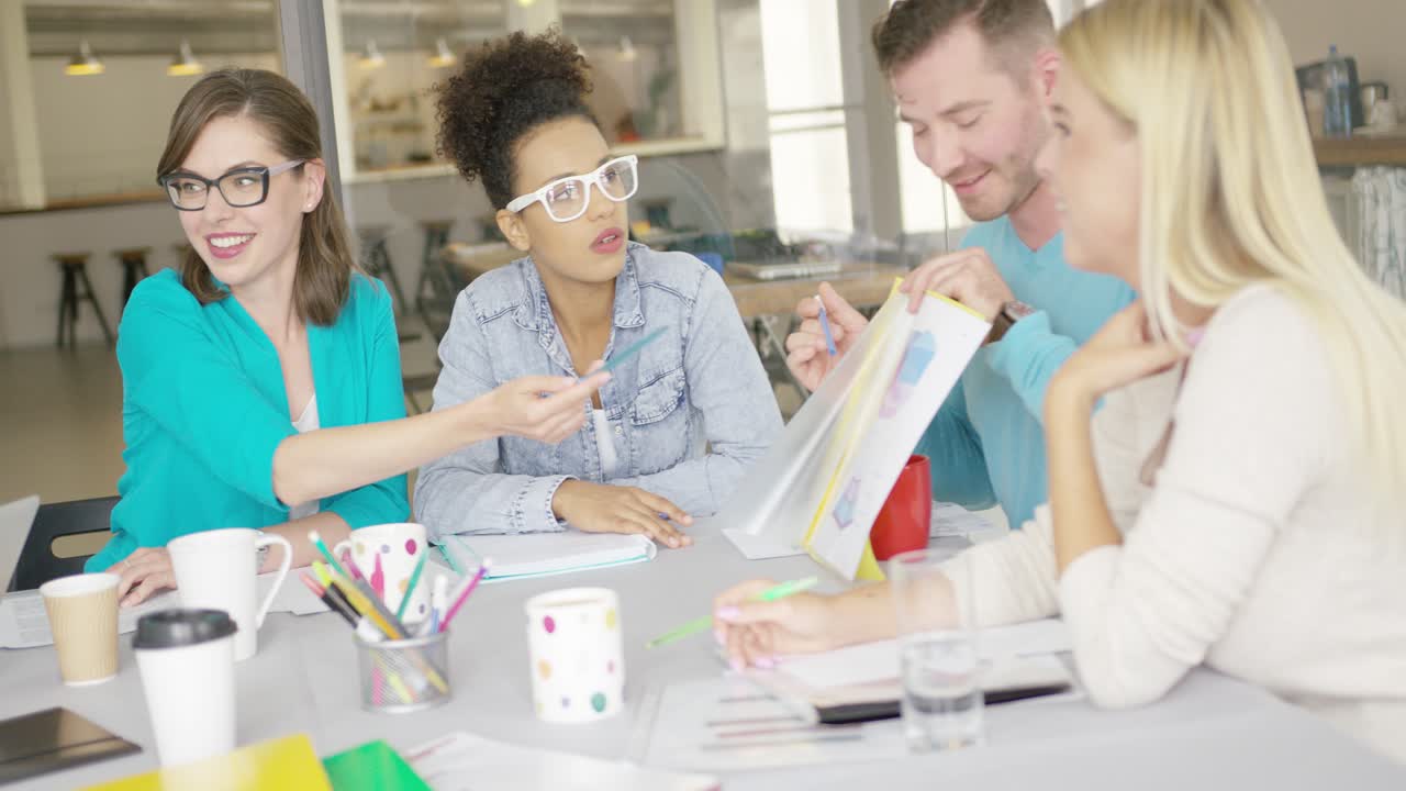 Premium stock video - Man sharing documents with coworkers