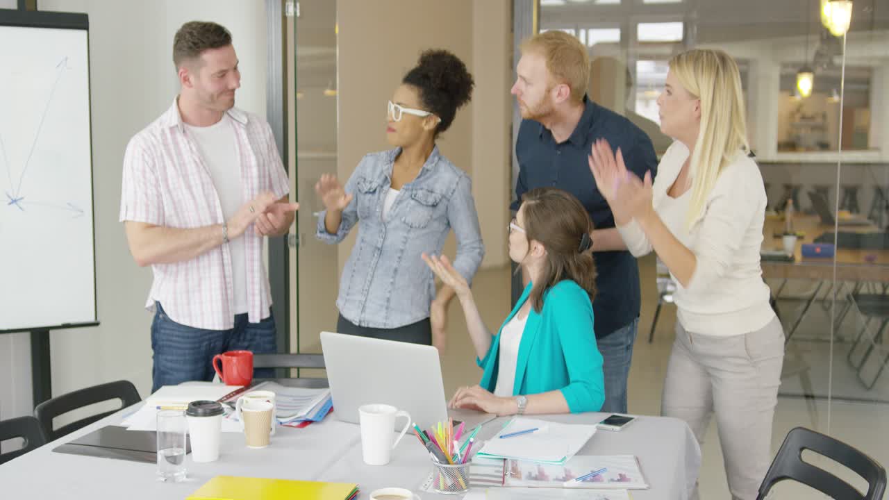 Premium stock video - Cheerful coworkers celebrating