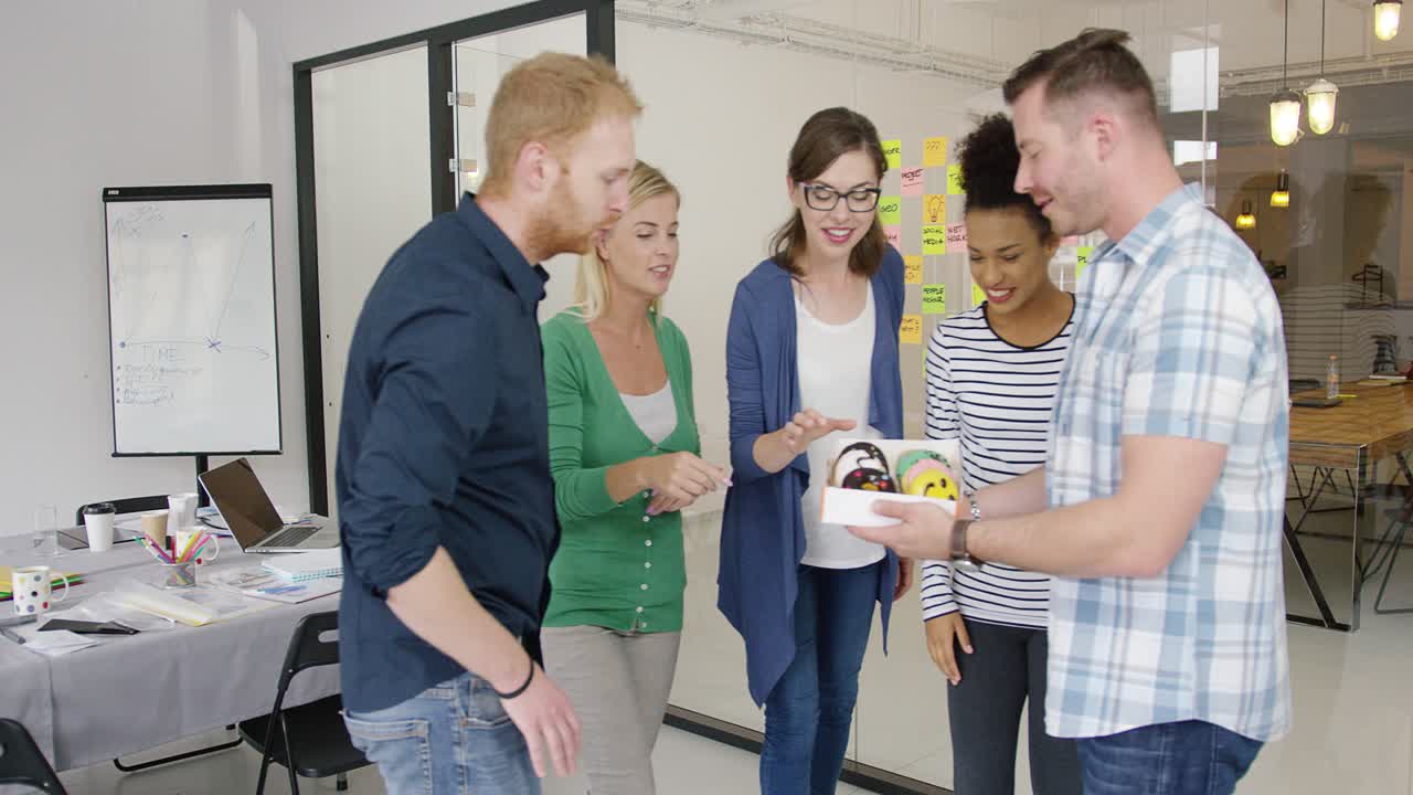 Premium stock video - Man sharing with colleagues