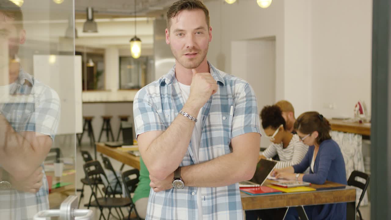 Premium stock video - Smiling male employee posing