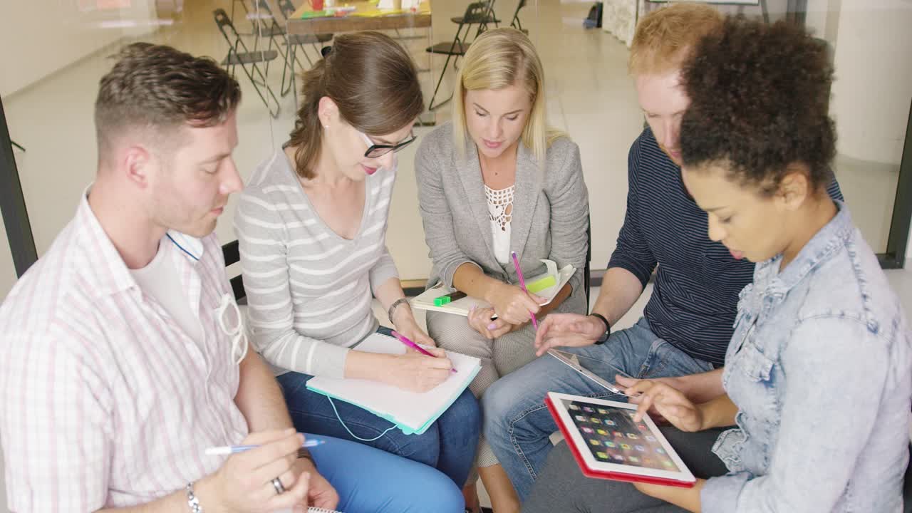 Premium stock video - Colleagues making notes