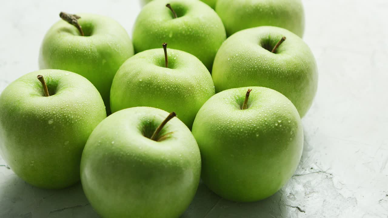 Premium stock video - Ripe green apples in drops