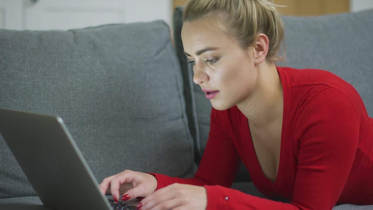 Premium stock video - Concentrated woman typing on laptop